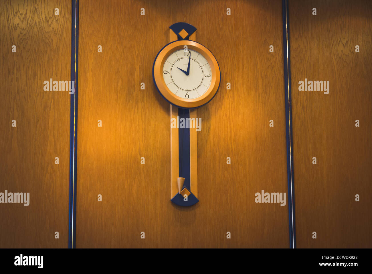 The clock hanging on the wall hi-res stock photography and images - Alamy