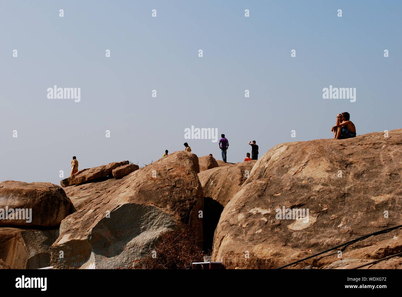 Group people sitting rocks hi-res stock photography and images - Alamy