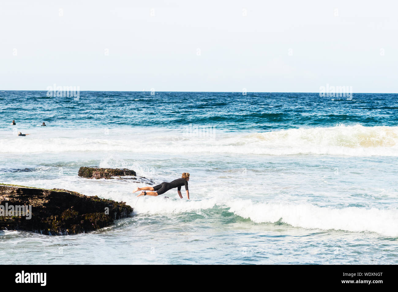 Male surfer jumping ocean wave hi-res stock photography and images - Alamy