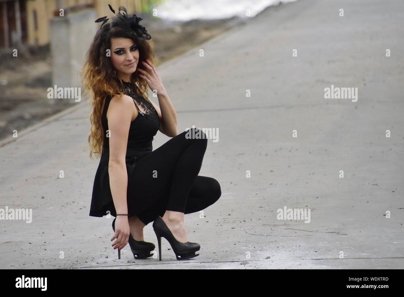Smiling young woman crouching hi-res stock photography and images - Alamy