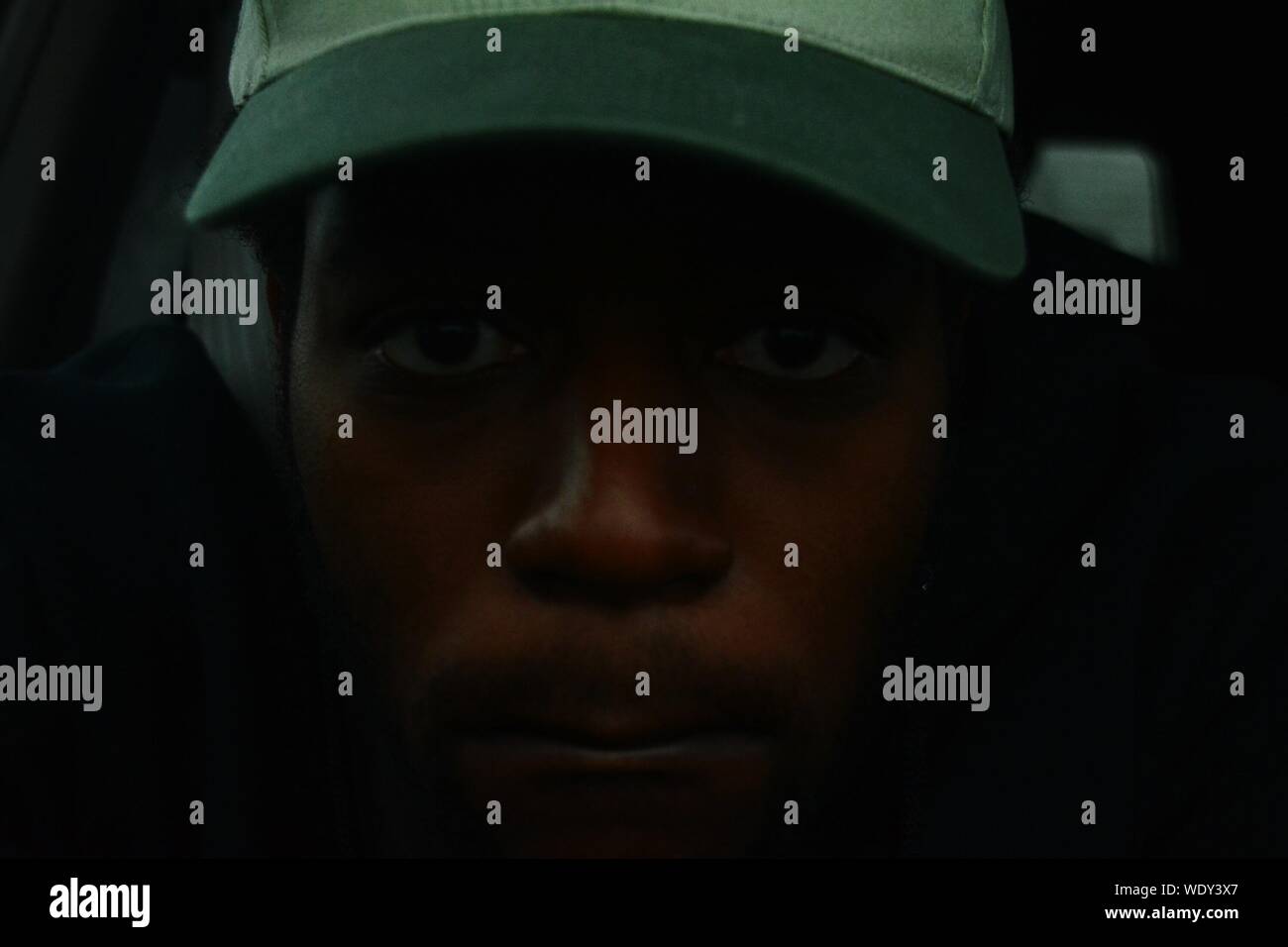 Man and green cap hi-res stock photography and images - Alamy
