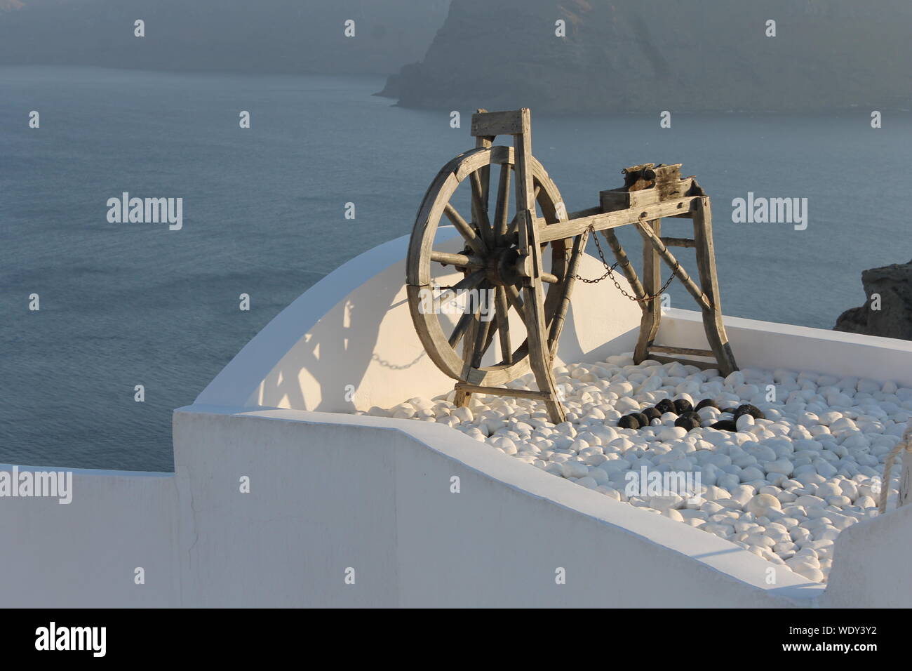 Old Wooden Spinning Wheel On Building By Sea Stock Photo - Alamy