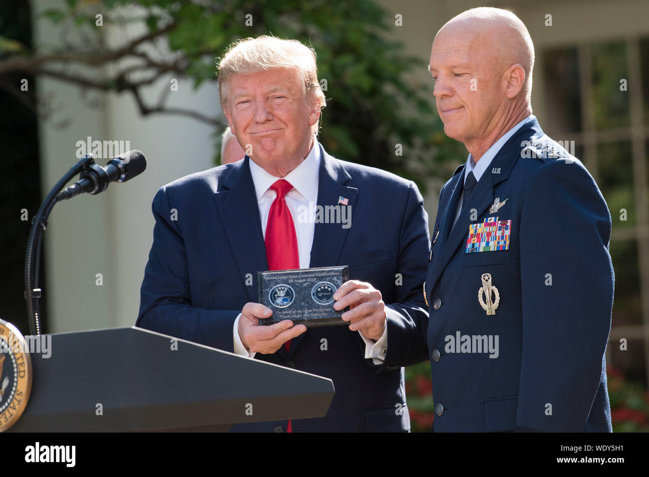 President Donald J. Trump receives a memento presented by the incoming ...
