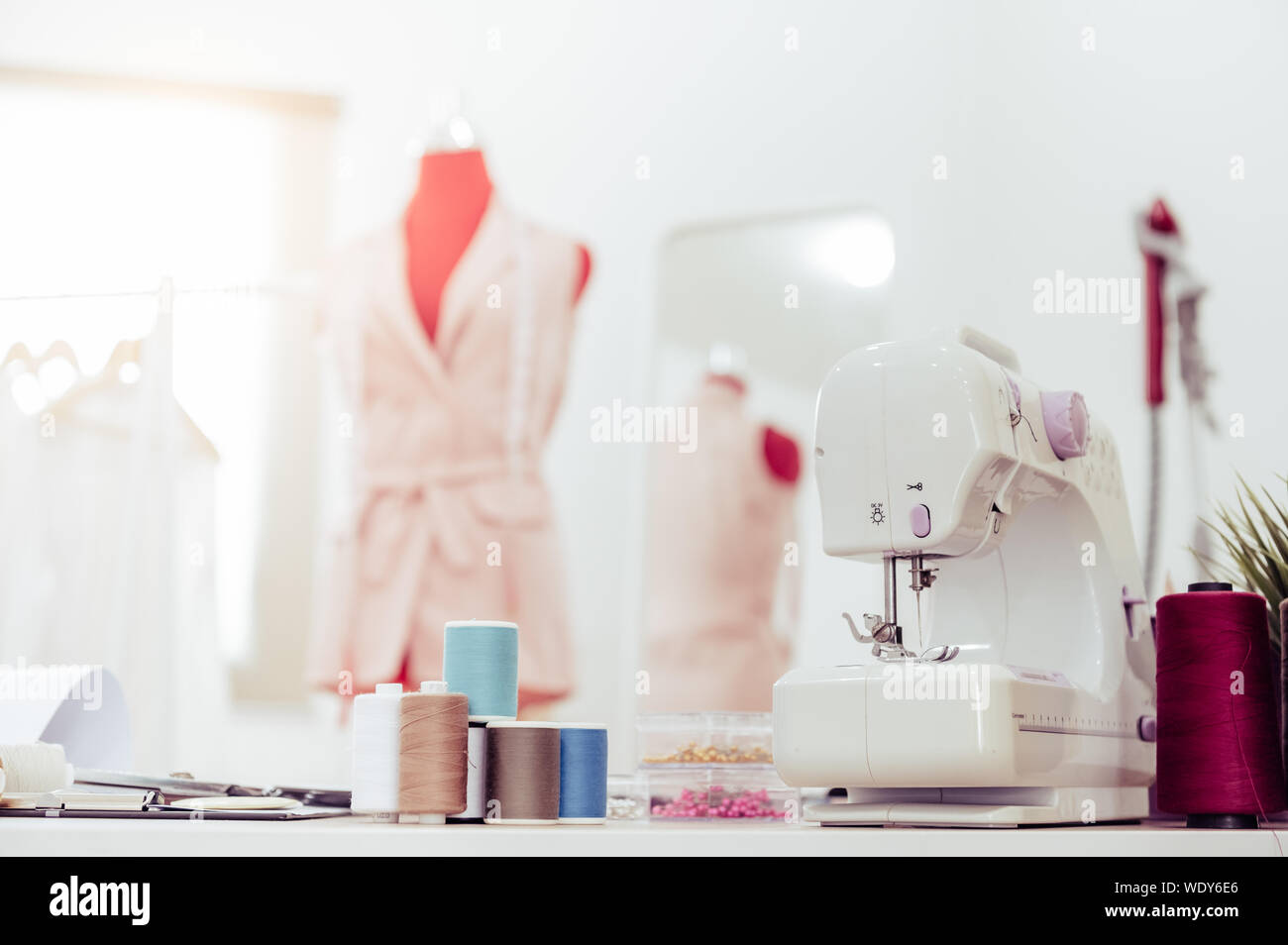 Closeup of sewing machine with fashion designer showroom studio ...