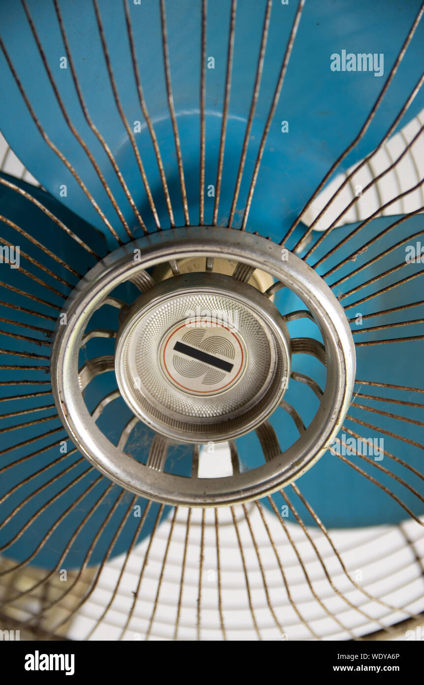 Vintage old white stand fan with blue blades Stock Photo - Alamy