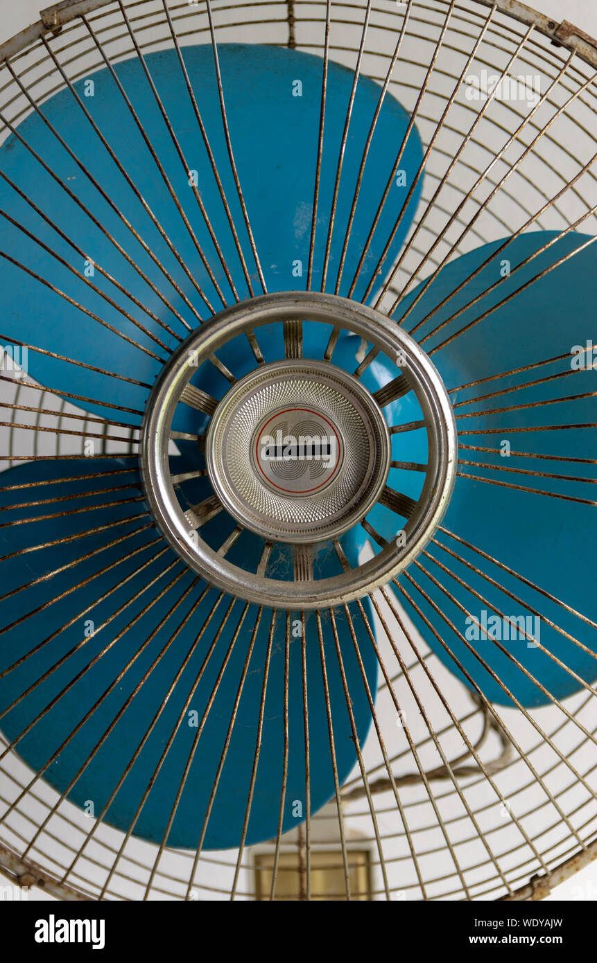 Vintage old white stand fan with blue blades Stock Photo - Alamy