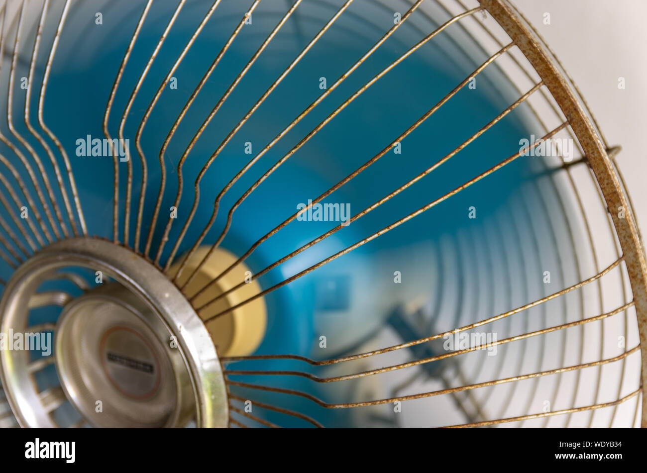Vintage old white stand fan with blue blades Stock Photo - Alamy