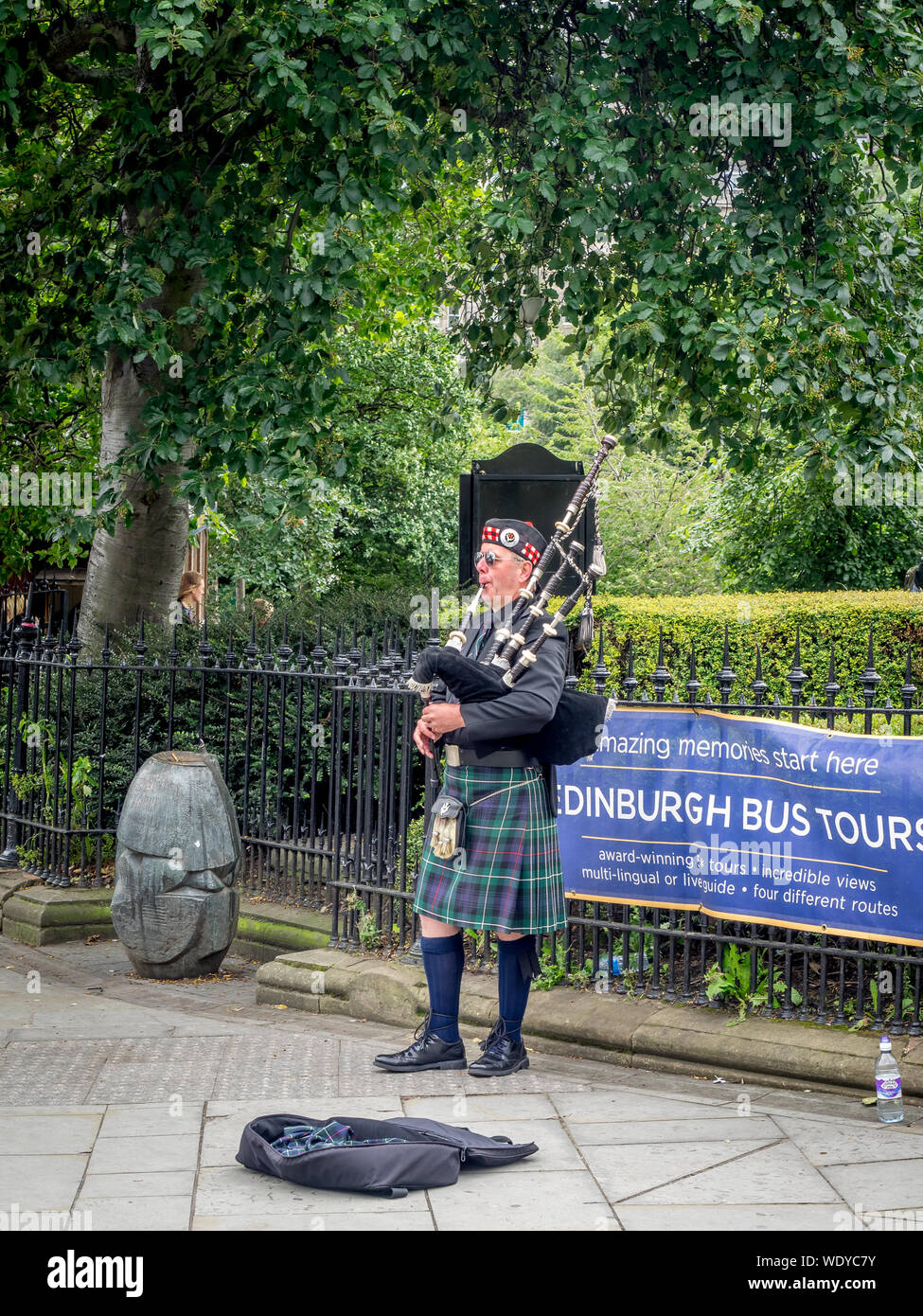 A Scotsman wearing traditional Scottish outfit playing the bagpipes ...