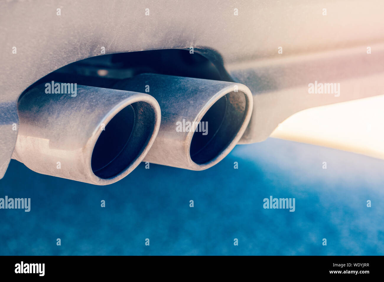 Closeup macro of dual double exhaust pipe. Detail of stylish blue car ...