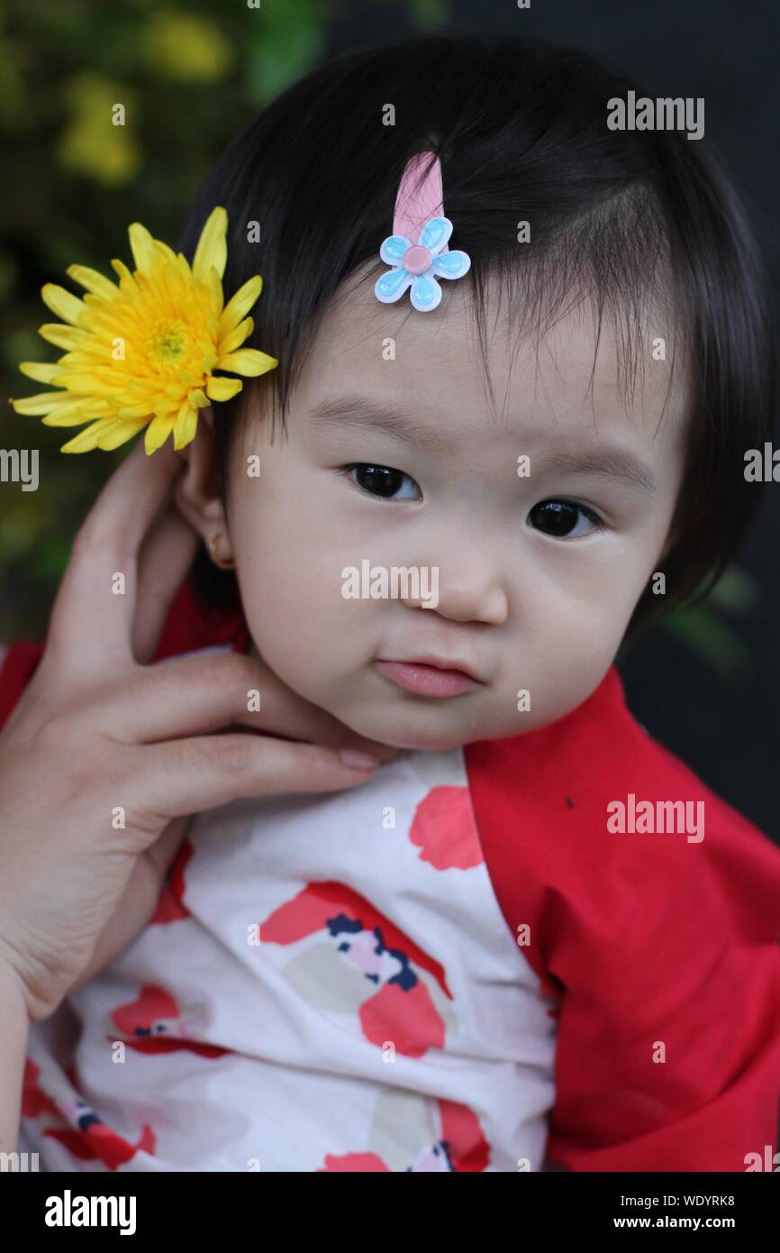 Baby and yellow flowers hi-res stock photography and images - Alamy
