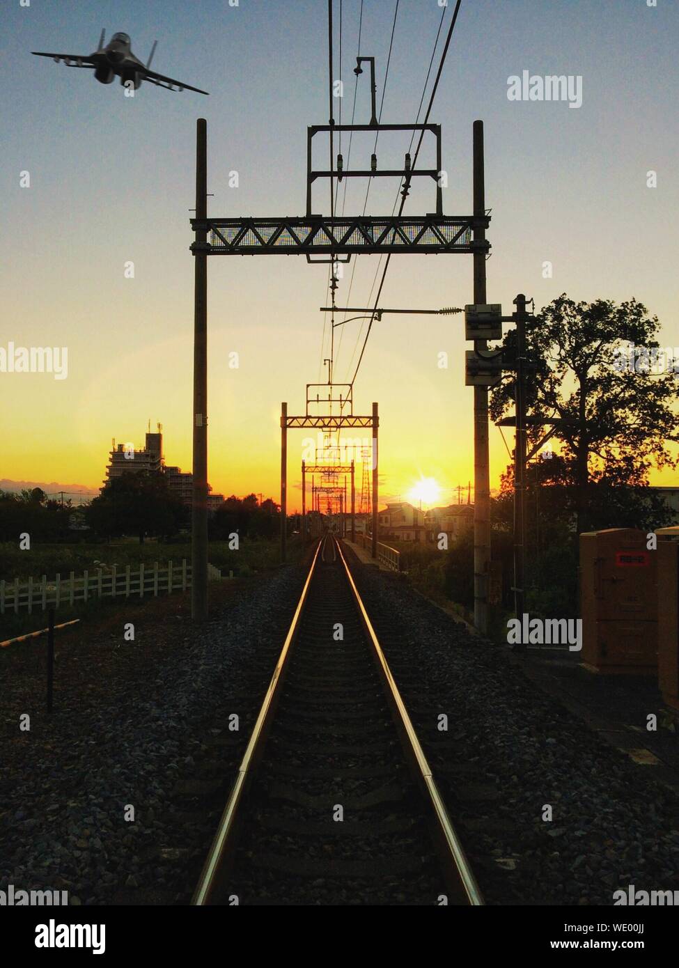 Airplane Flying Over Railroad Tracks Stock Photo - Alamy