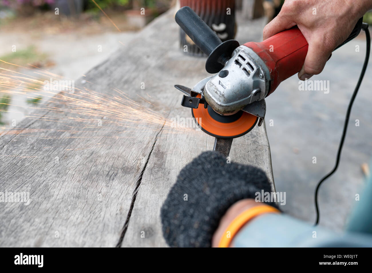 Worker are whetting blade shovel with electric saw and sparkle Stock ...