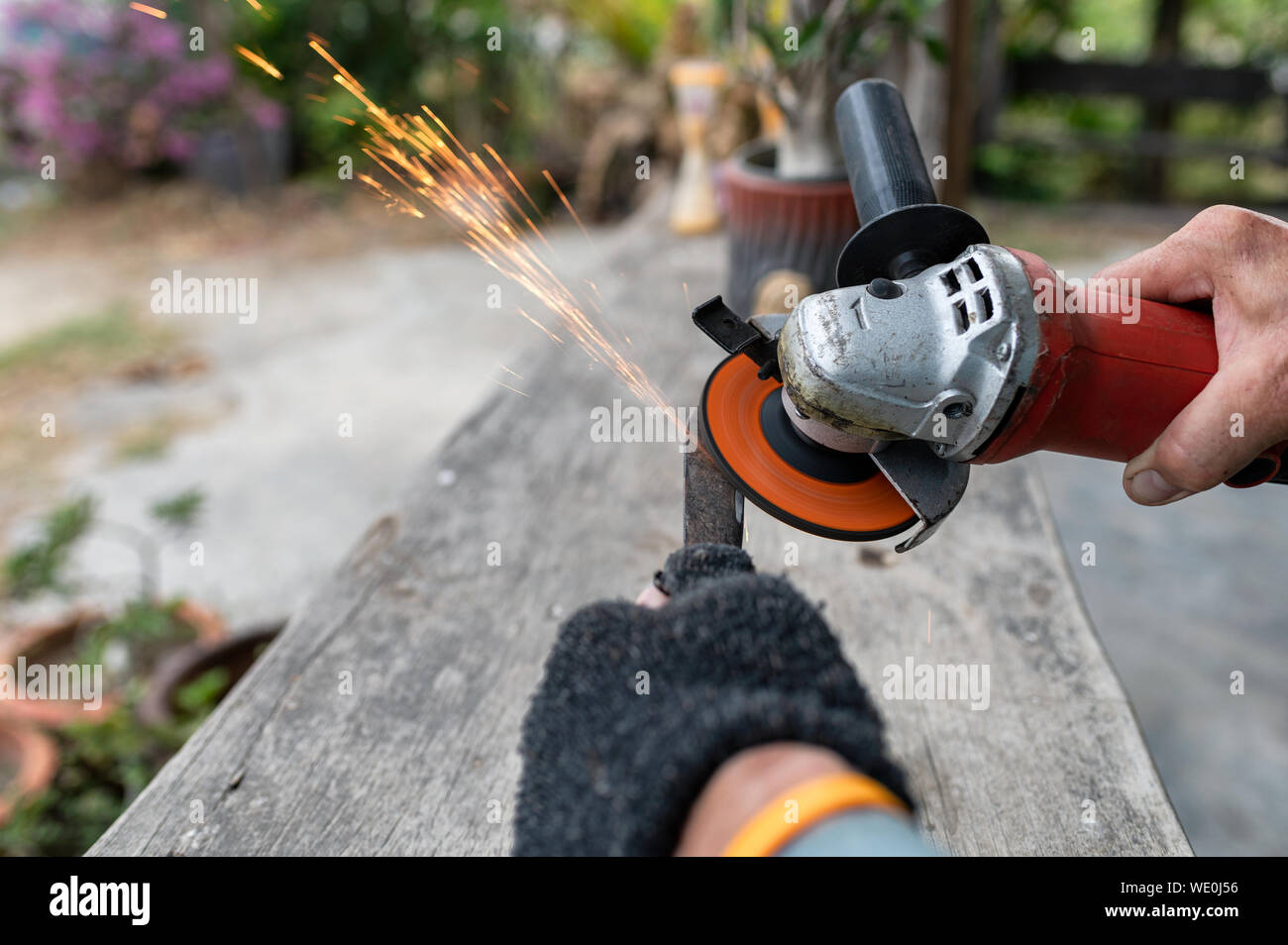 Worker are whetting blade shovel with electric saw and sparkle Stock ...