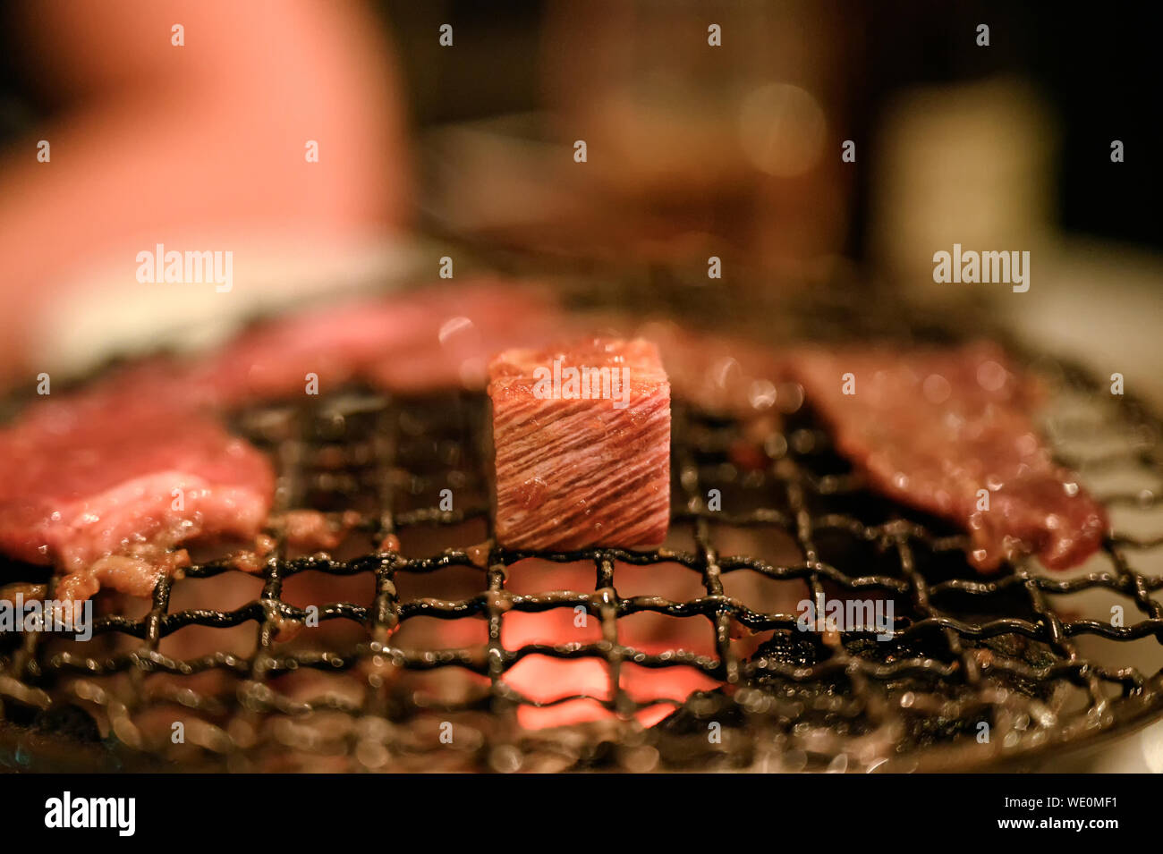 Grilled raw beef slice on flaming charcoal grill Stock Photo - Alamy