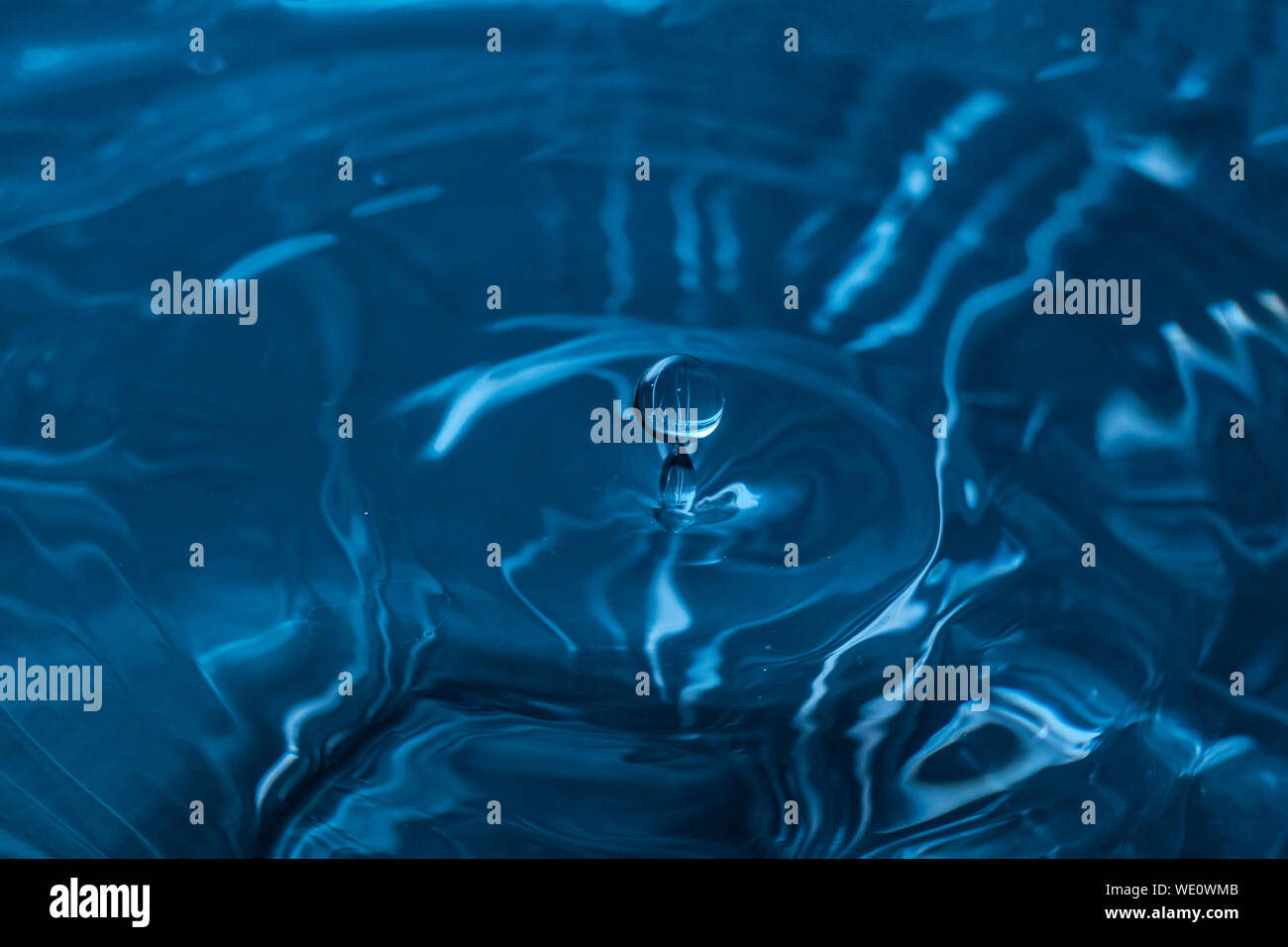 Drop of water. Blue water drop. Falling water. Water splash close-up ...