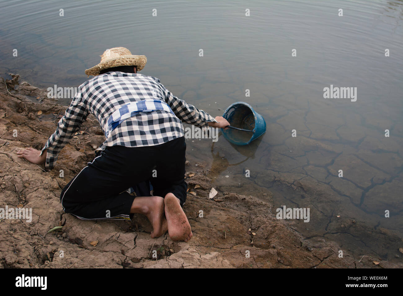 Man bucket water hi-res stock photography and images - Alamy