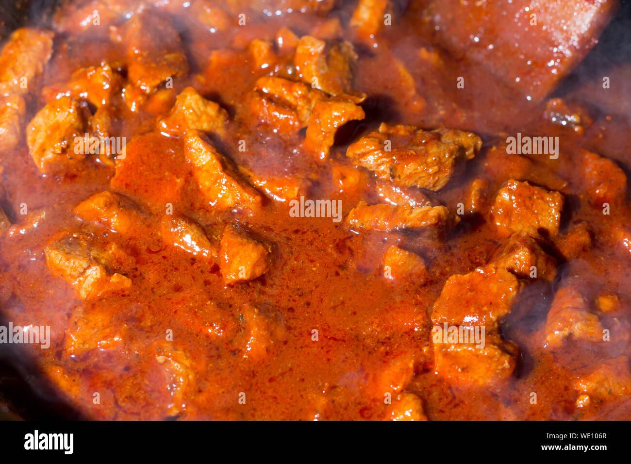 Cooking meat with gravy. Fried pieces of meat in a pan. Roasted meat ...