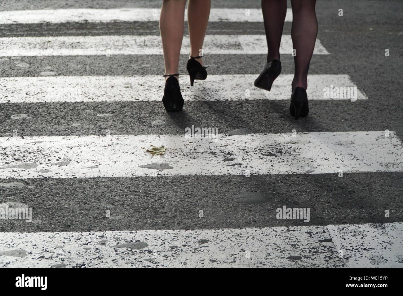 Two women crossing the road hi-res stock photography and images - Alamy