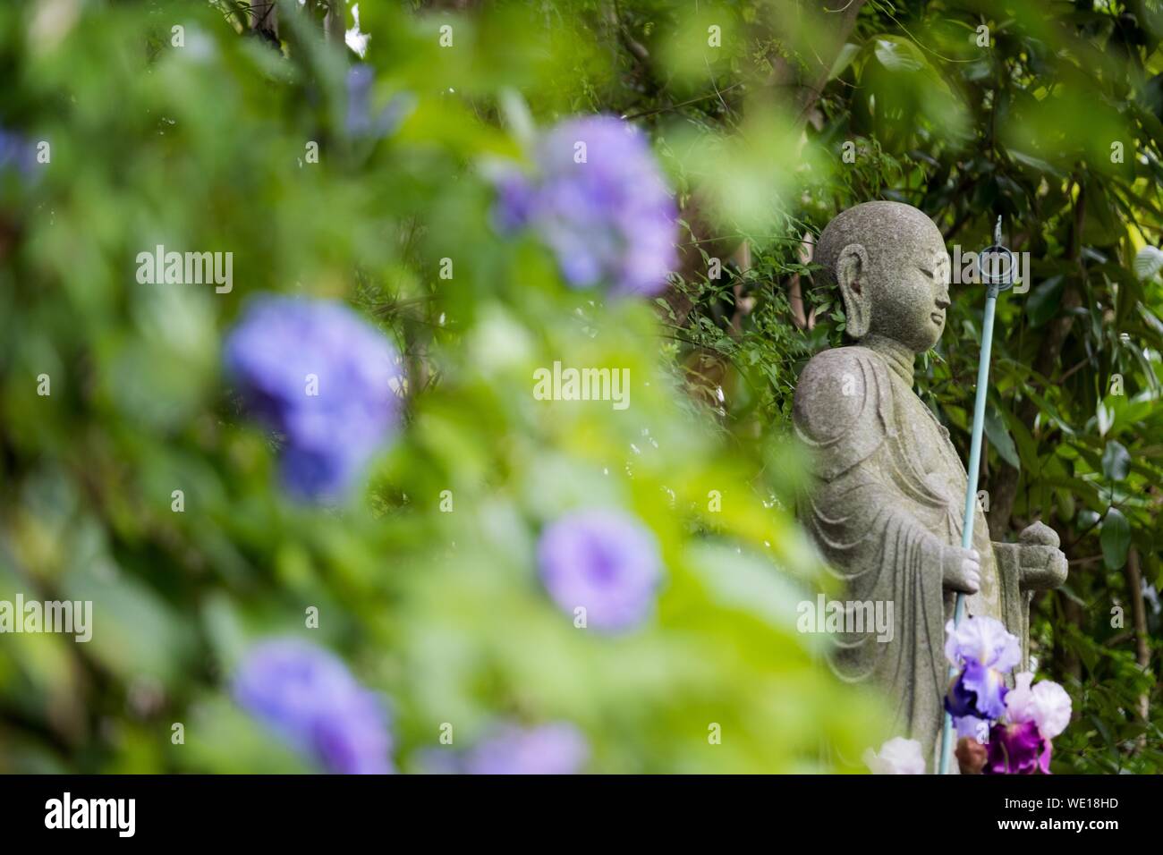Statue With Flowers High Resolution Stock Photography and Images - Alamy