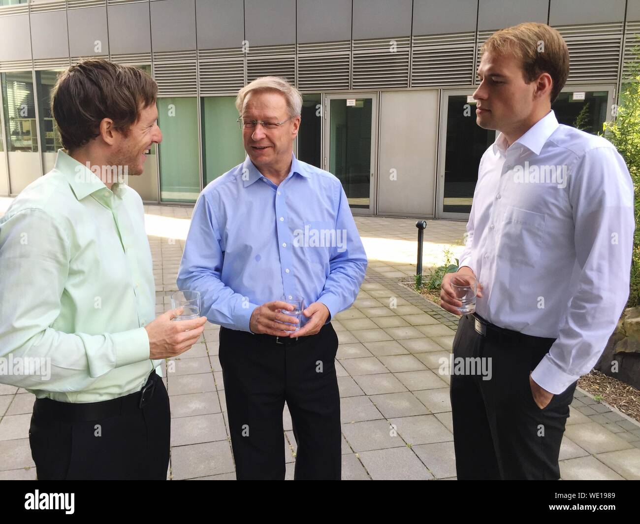 Smiling talking outside building hi-res stock photography and images ...