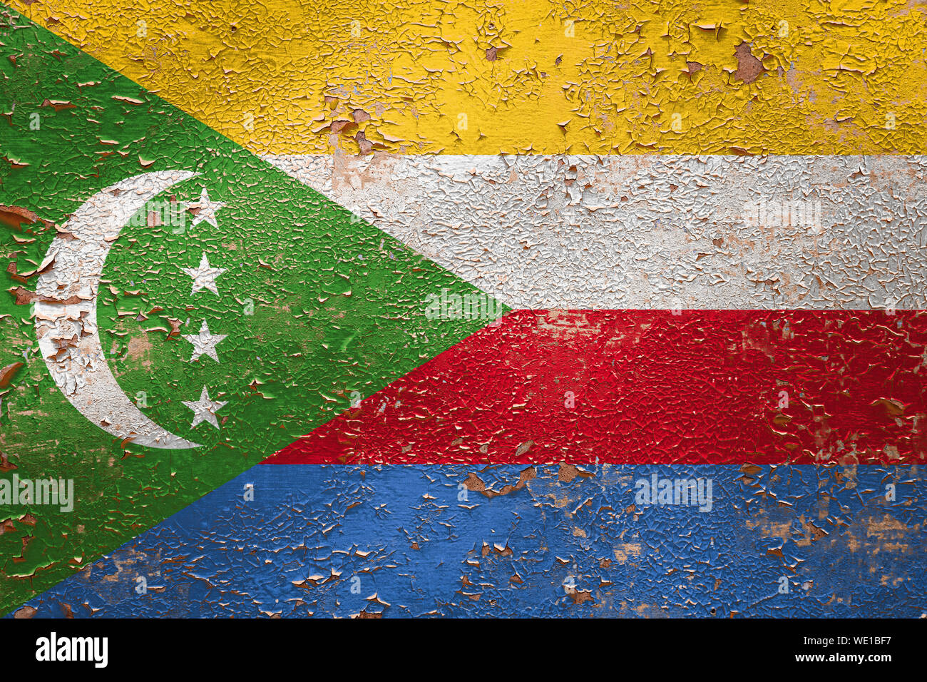National flag of Comoros on old peeling wall background.The concept of ...