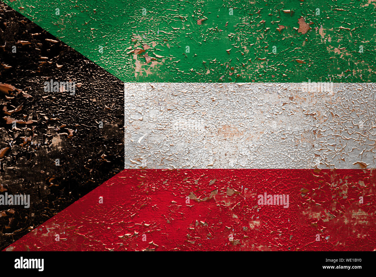 National flag of Kuwait on old peeling wall background.The concept of ...