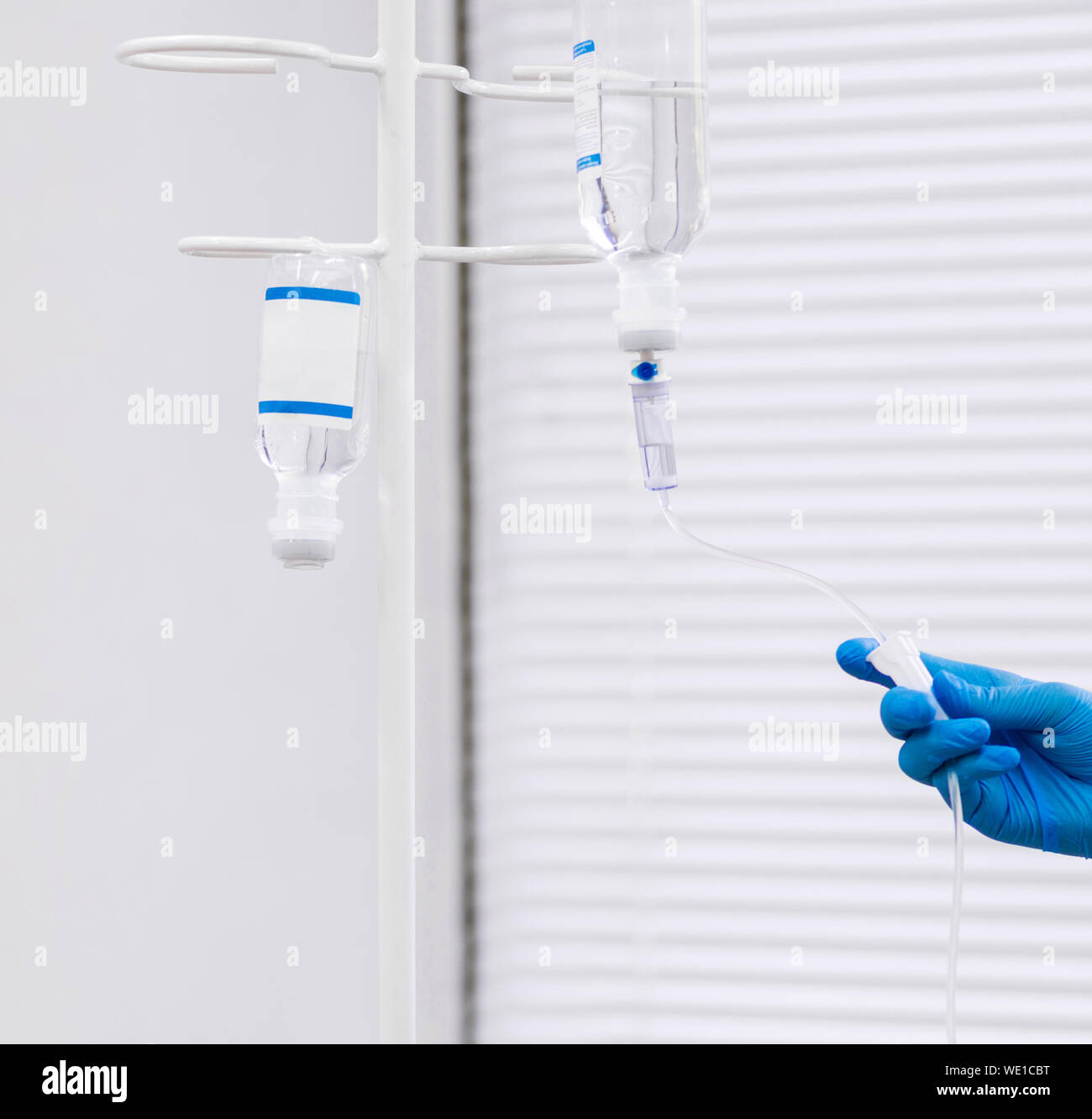 the doctor prepares the system with a dropper and a solution Stock ...