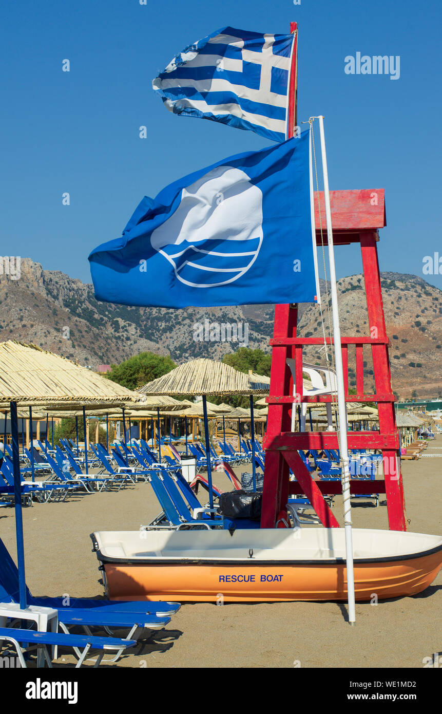 Flag of Greece and the Blue flag are flying over the rescue tower on ...