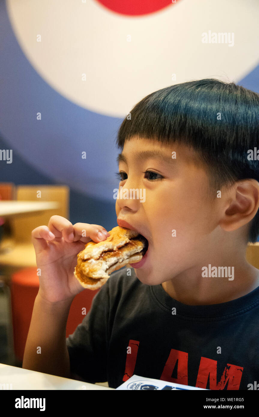 Hungry boy eating burger hi-res stock photography and images - Alamy