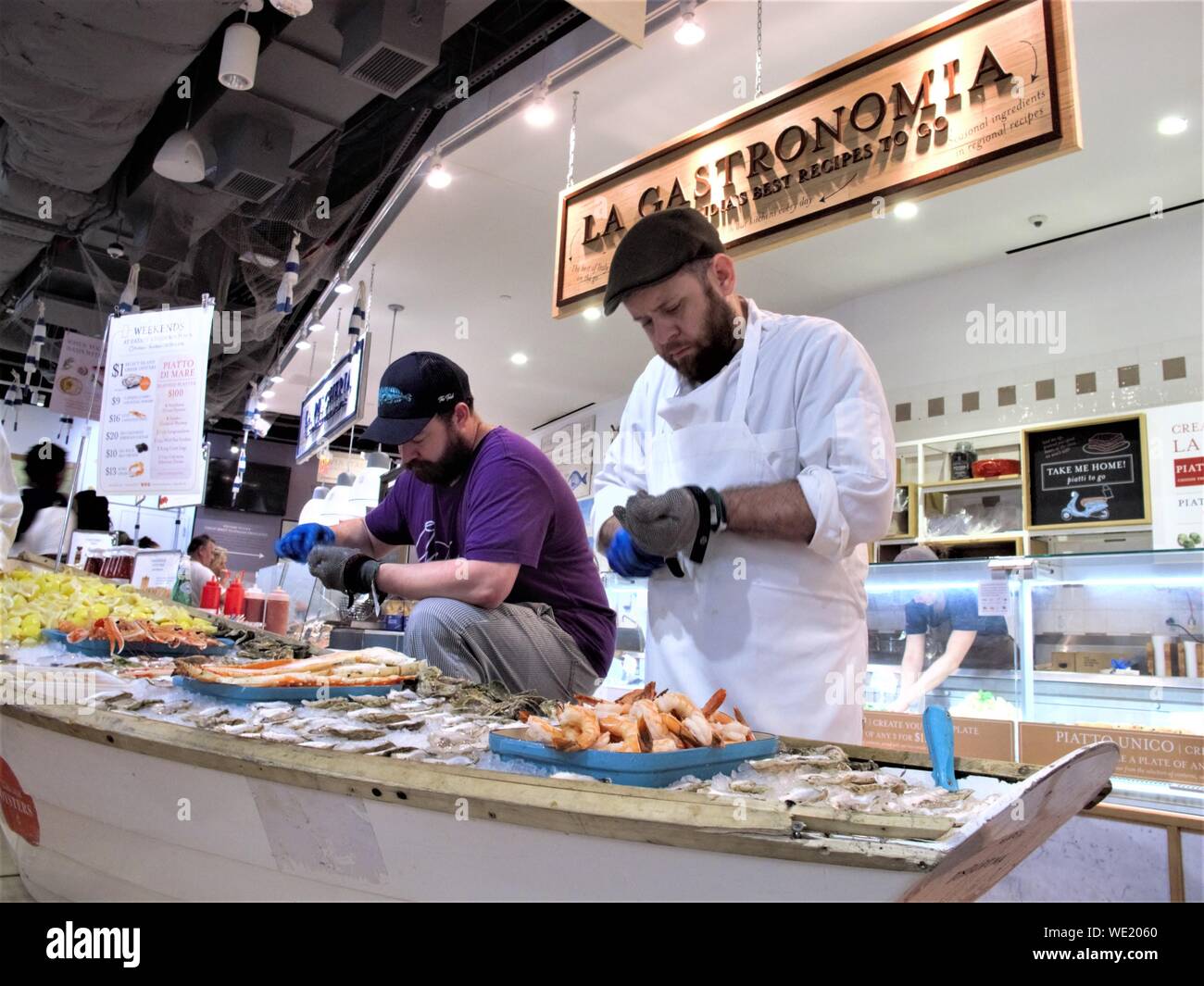 TWO PEOPLE AT WORK INSIDE EATALY FOOD STORE IN OCULUS WORLD TRADE ...