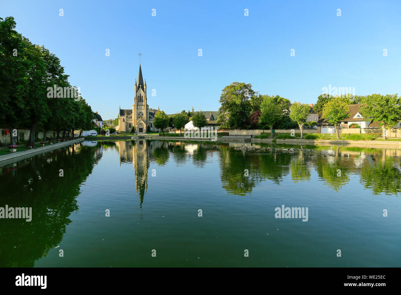 Charming village of Gueux with its lakeside church, near Reims in the ...