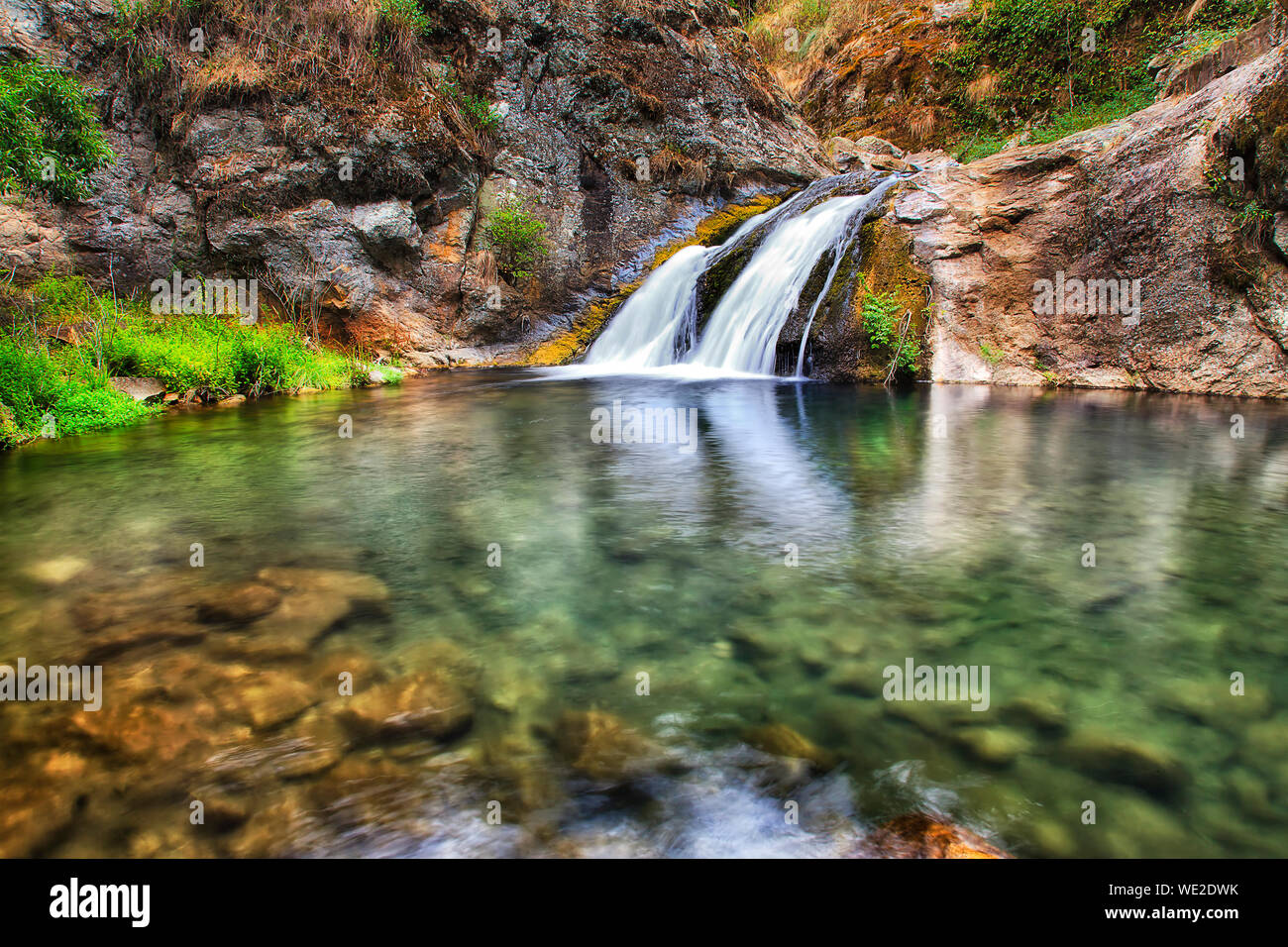 Small smooth waterfrall on Jenolan river streaming into small shallow ...