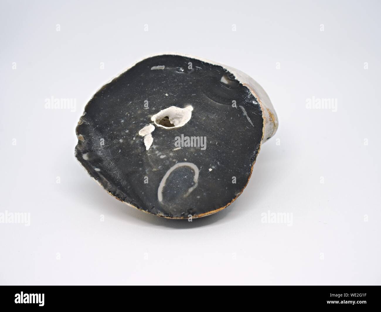 Broken stone with hole or cavity, the rock isolated on white background ...