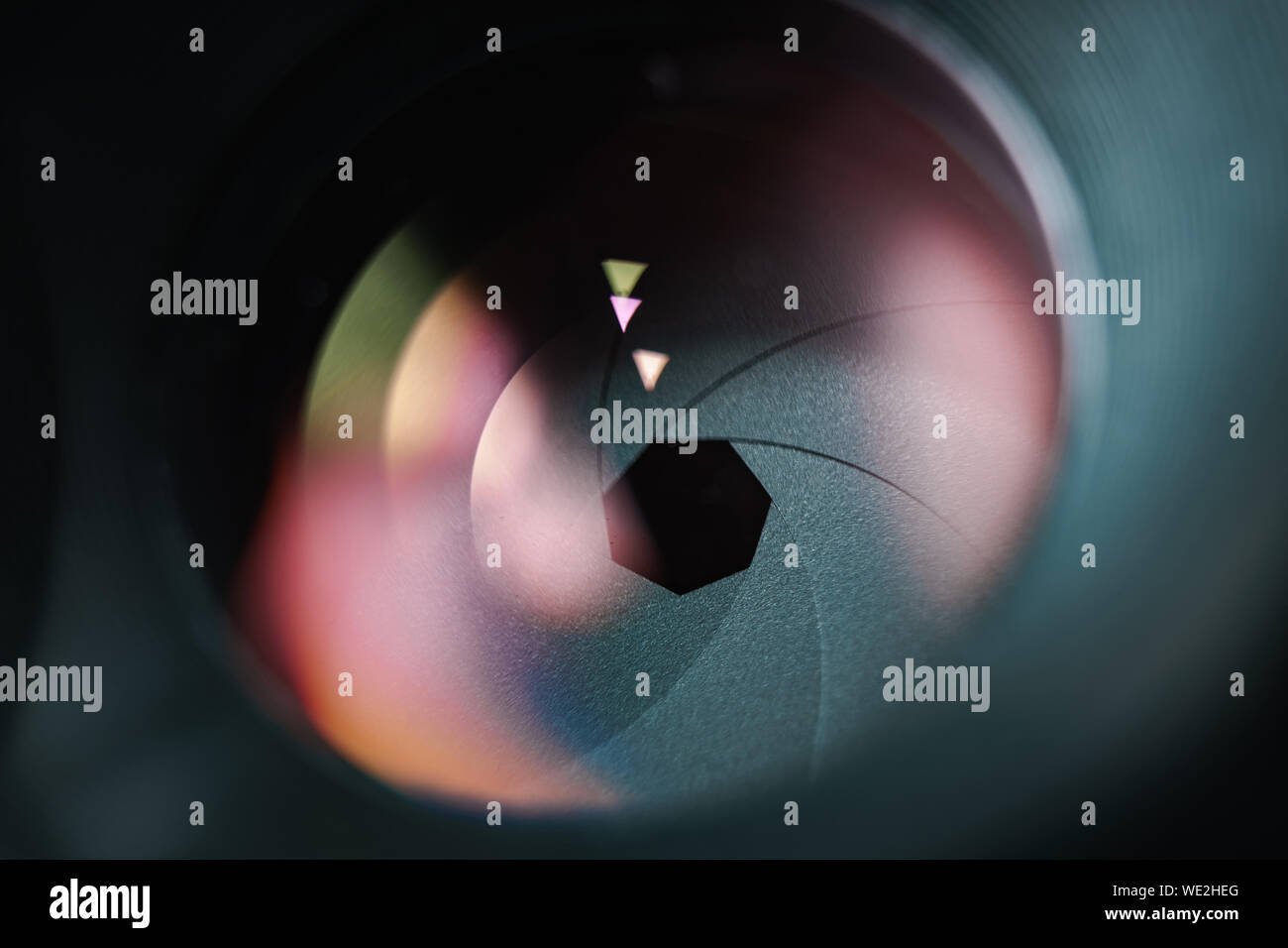 Beautiful camera lens with yellow and pink light of glass on a black ...