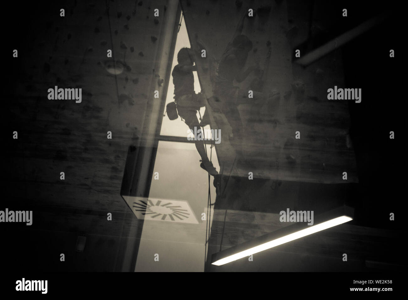 Person climbing glass wall hi-res stock photography and images - Alamy