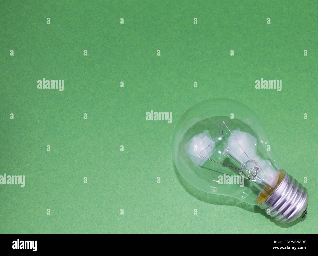 incandescent bulb on a green background, there is an empty space to ...
