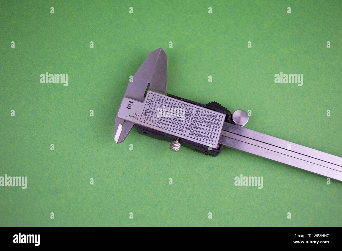 caliper with digital screen on a green background, there is free space ...