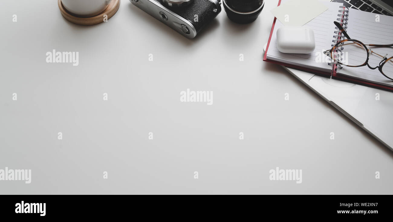 Top view of photographer workplace with laptop, cameras and office ...