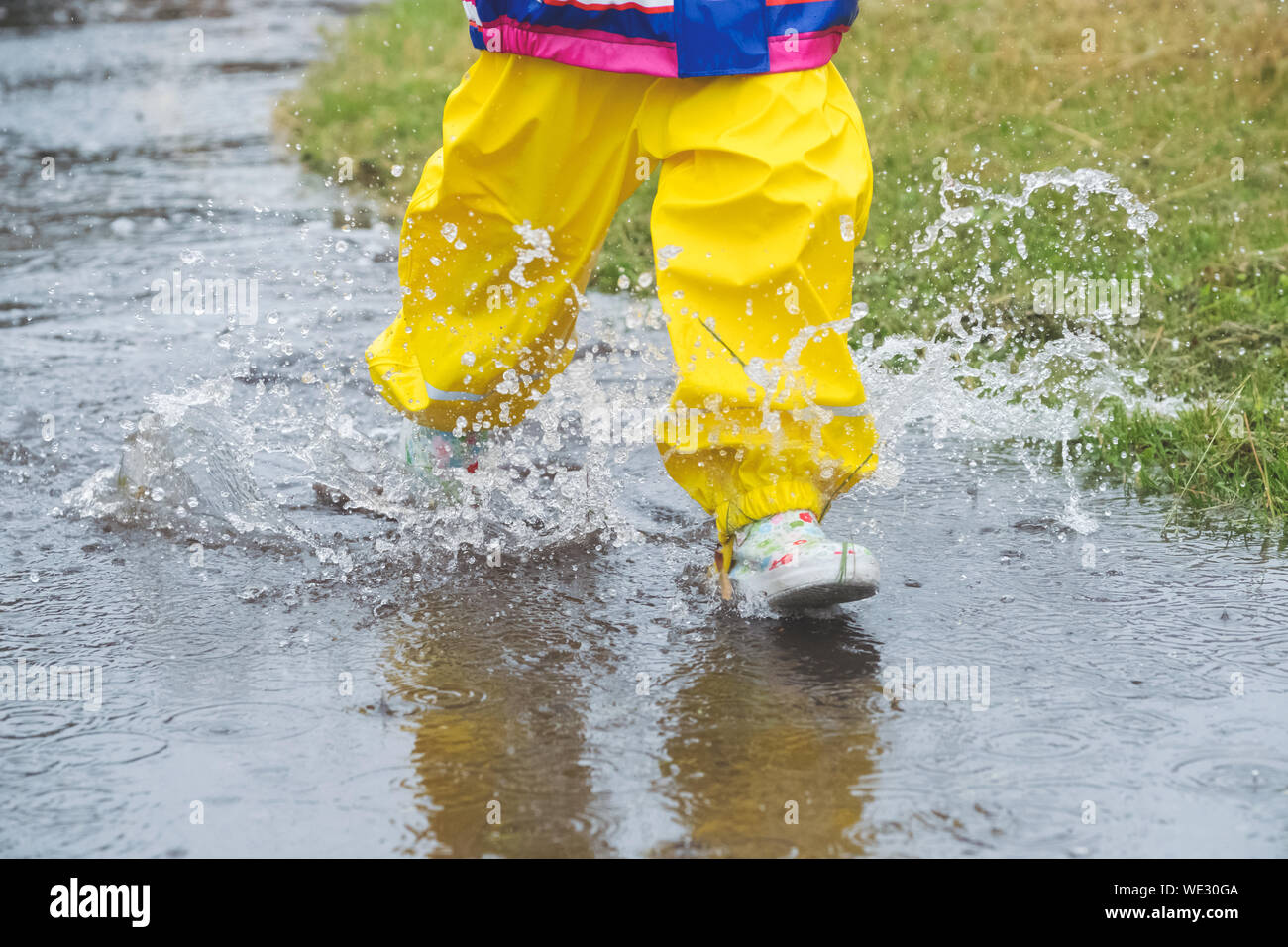 Girl jumping in muddy puddle hi-res stock photography and images - Alamy