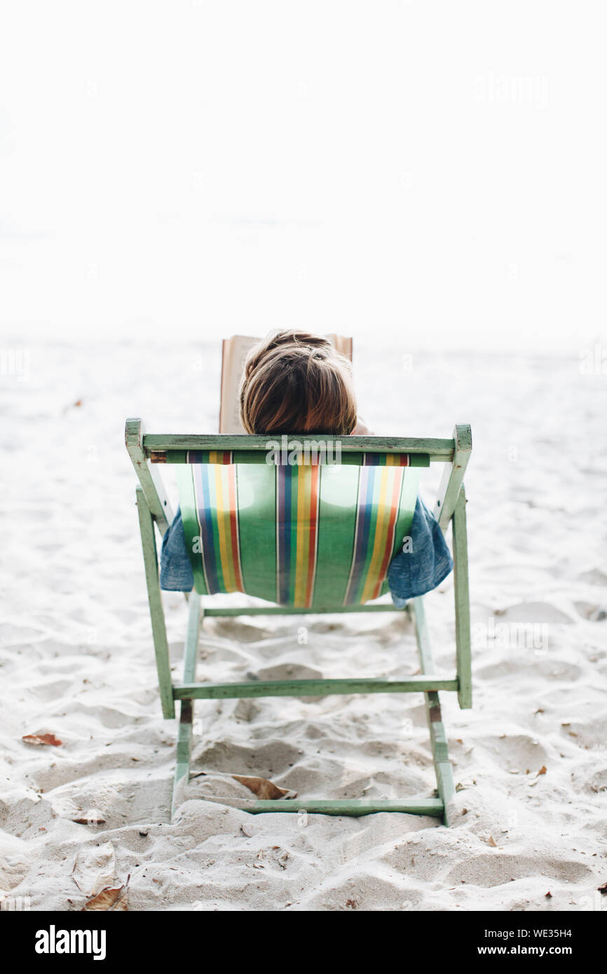 Woman Lying On Lounge Chair High Resolution Stock Photography and ...