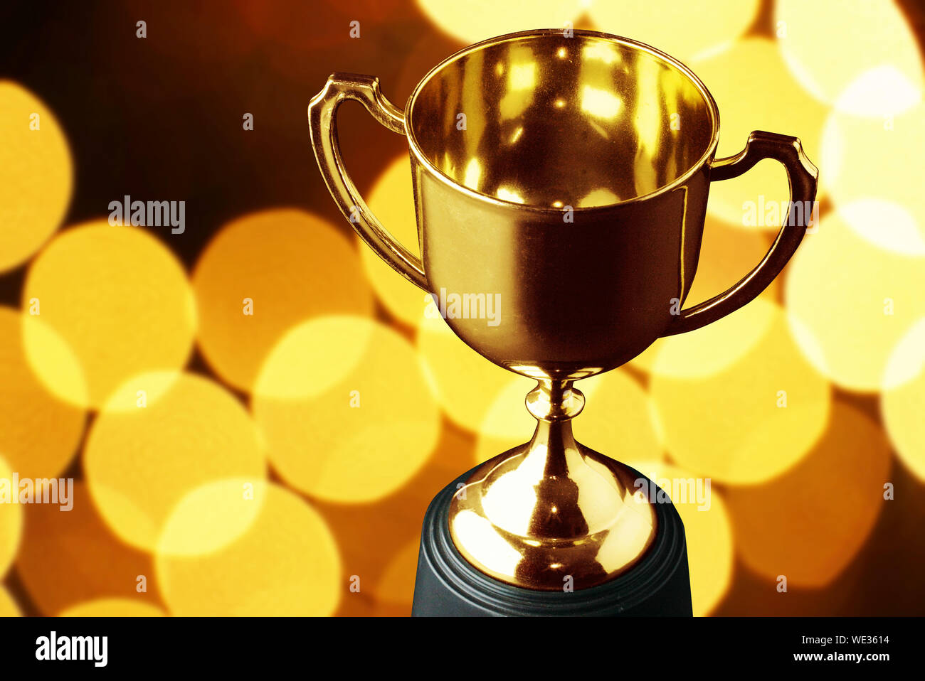 Shinny gold trophy with background night light bokeh , winner party ...