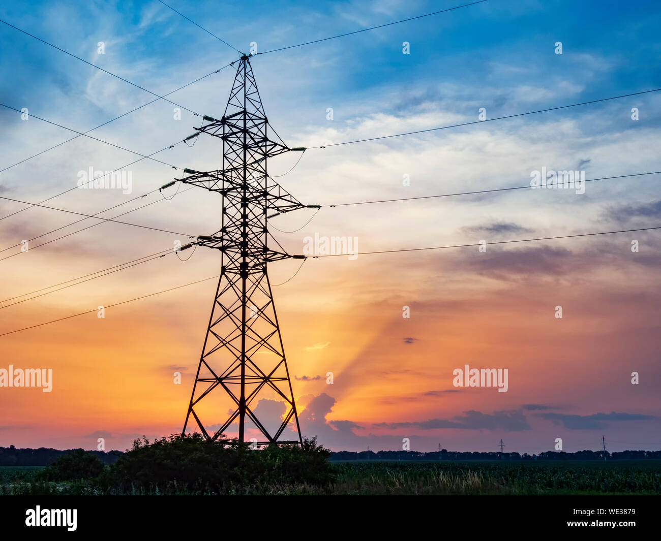 Power lines support at sunset. Beautiful industrial landscape ...