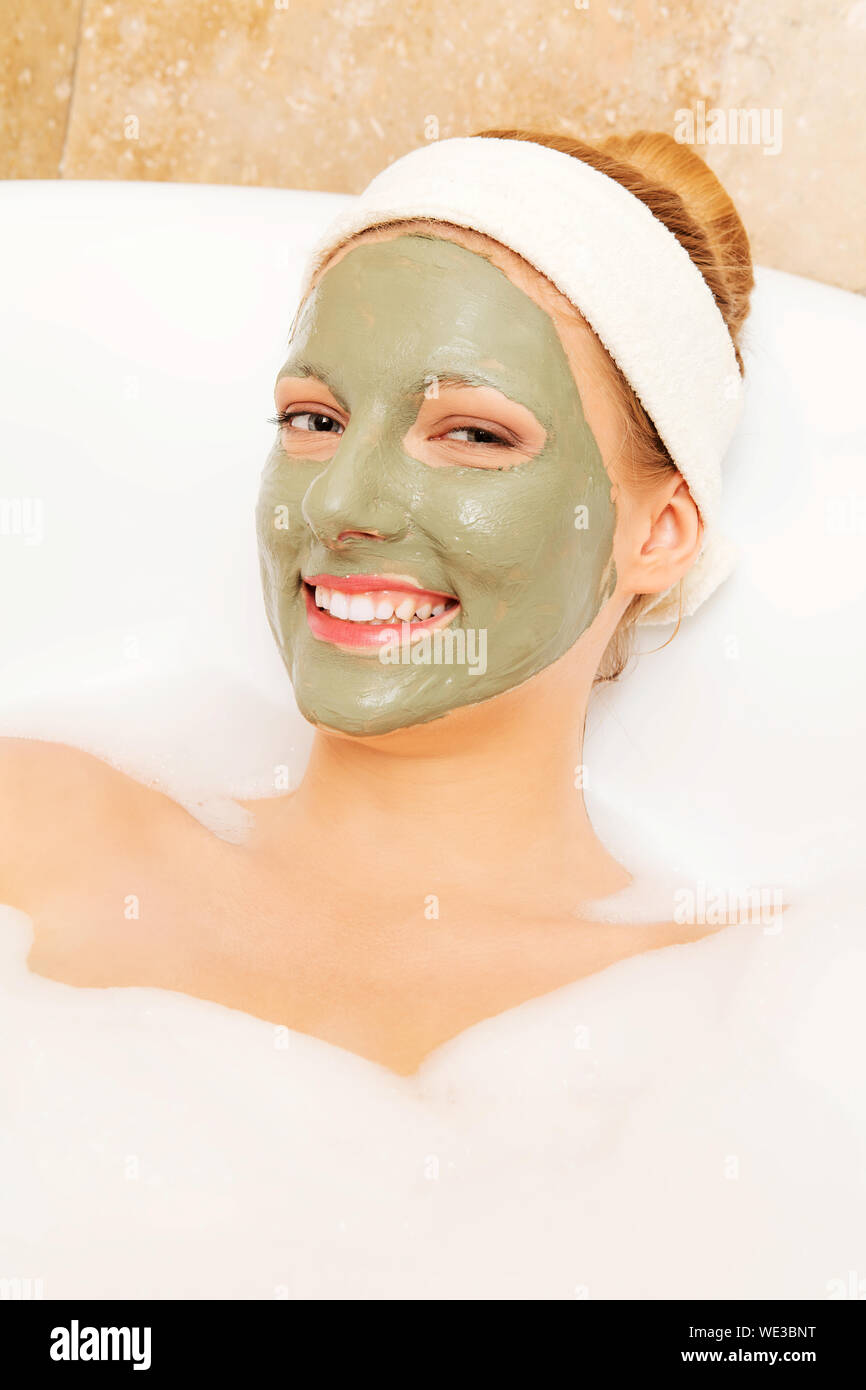 Smiling young woman green facial mask hi-res stock photography and ...
