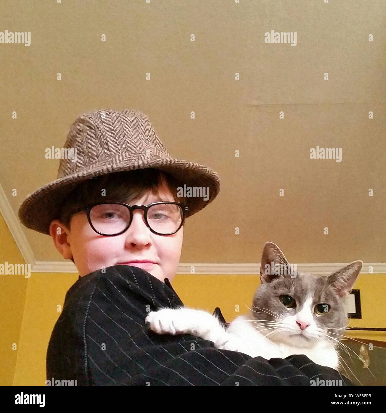 Portrait Of Cute Boy Holding Cat At Home Stock Photo - Alamy