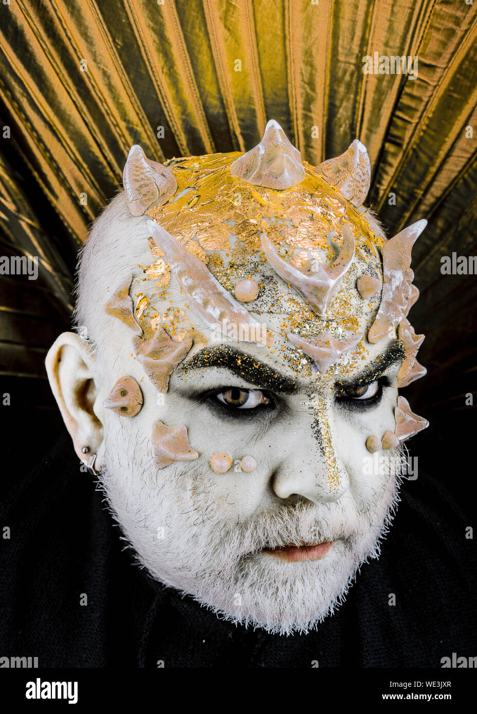 Head with thorns or warts, face covered with glitters, close up ...