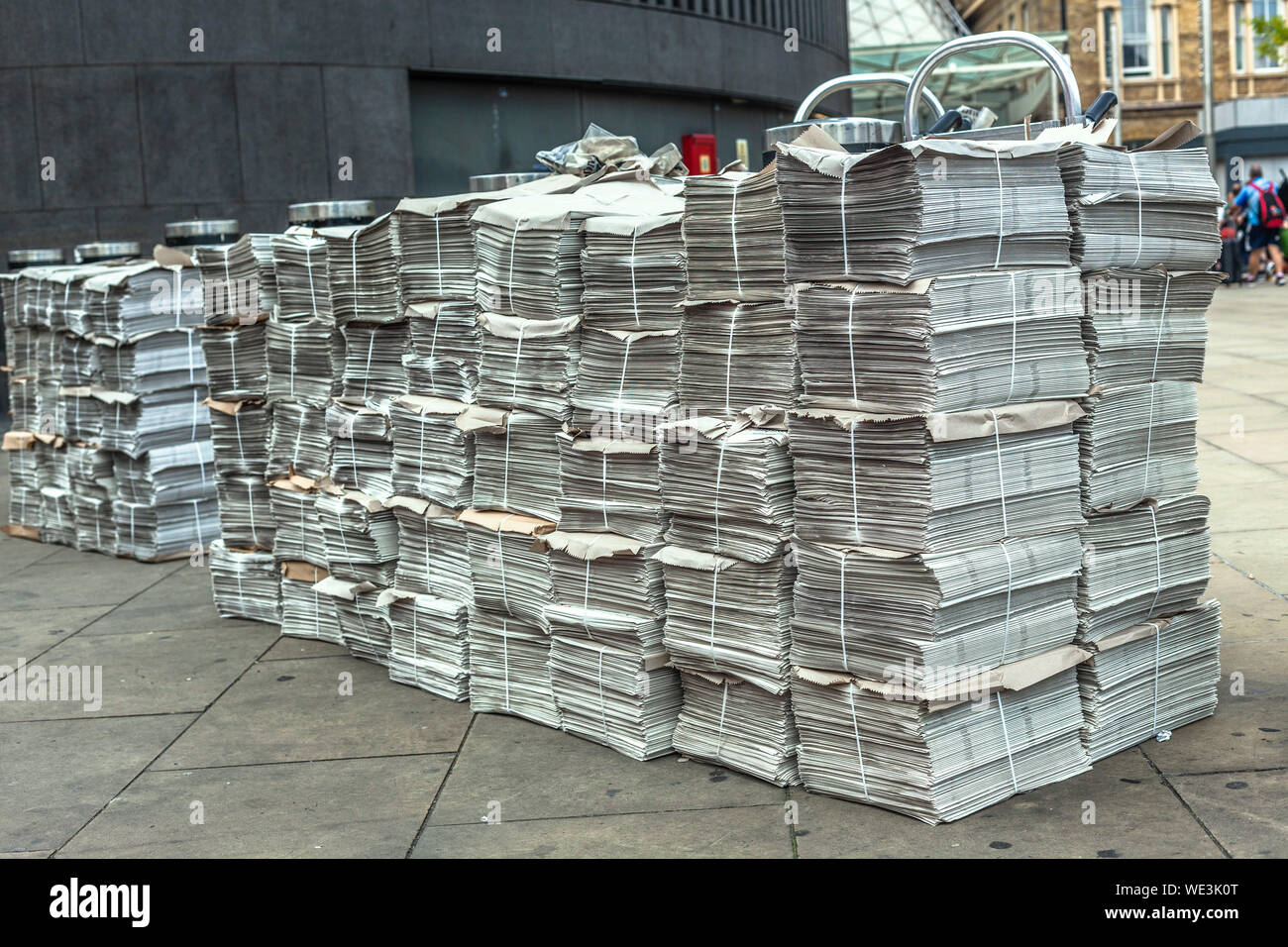 Rows of newspaper stacks lined up on a pavement, London, England, UK ...