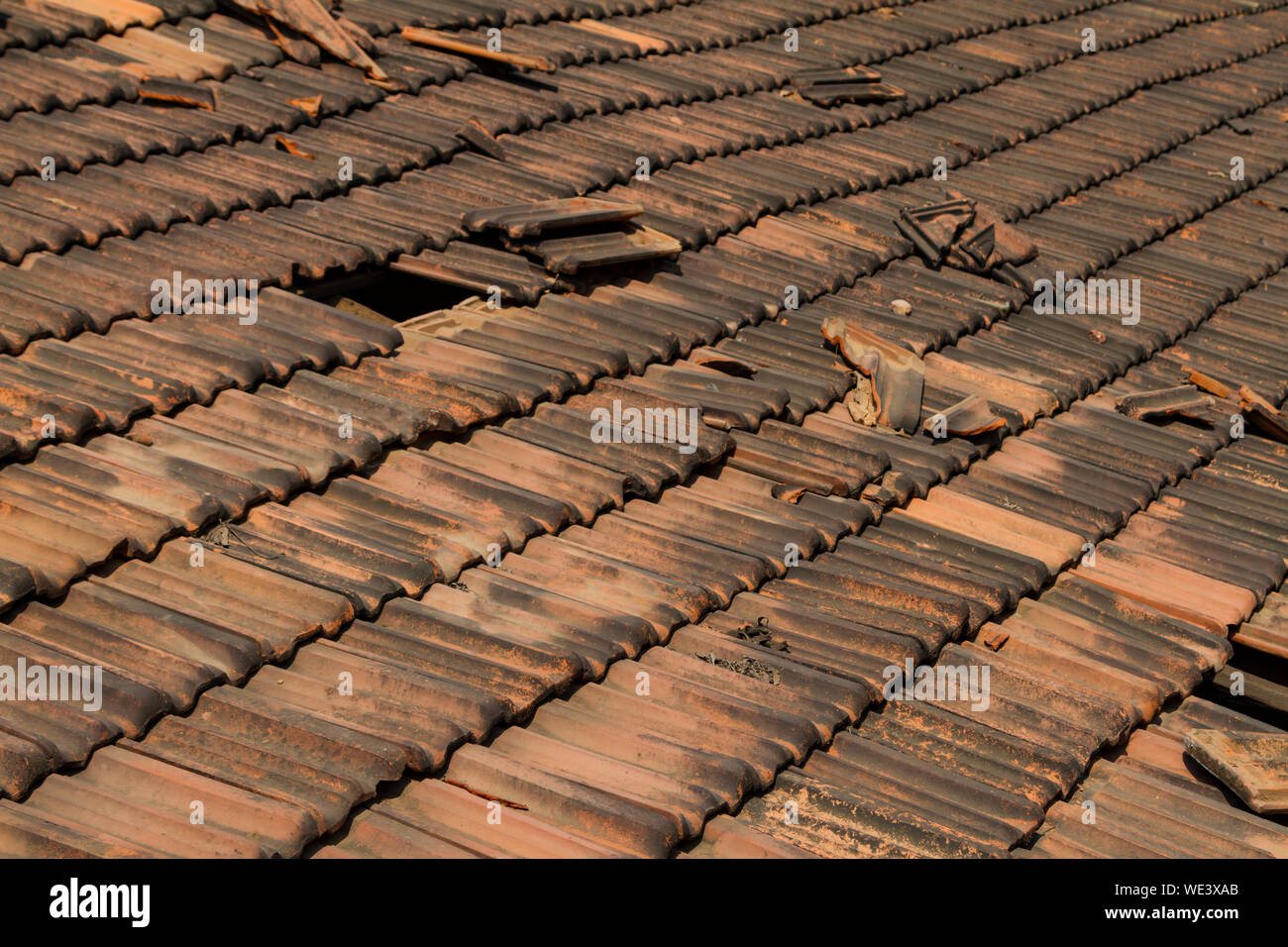 Broken old terracotta rooftiles with hole, traditional cover in India ...