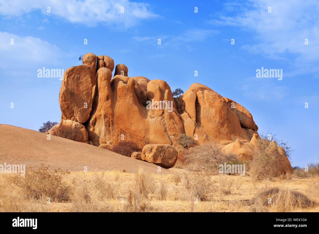 Red bald granite peaks on blue sky background, ancient geological ...