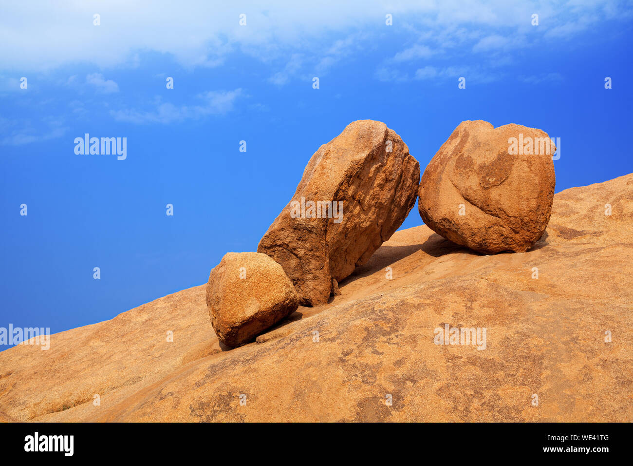 Red bald granite peaks on blue sky background, ancient geological ...