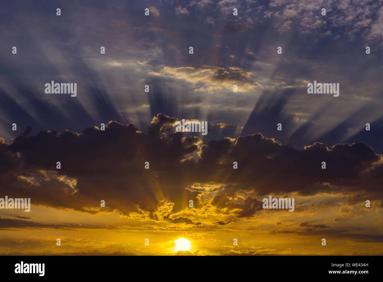 Sun shining through storm clouds hi-res stock photography and images ...